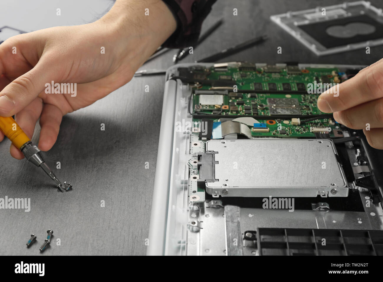 Man fixing disassembled laptop, closeup. Concept of computer repair ...