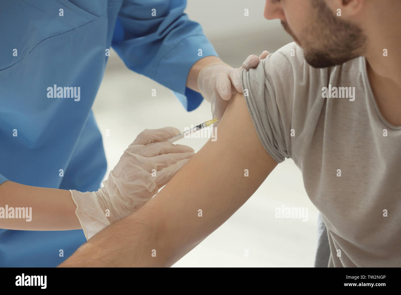 Injection in shoulder hands syringe hi-res stock photography and images ...