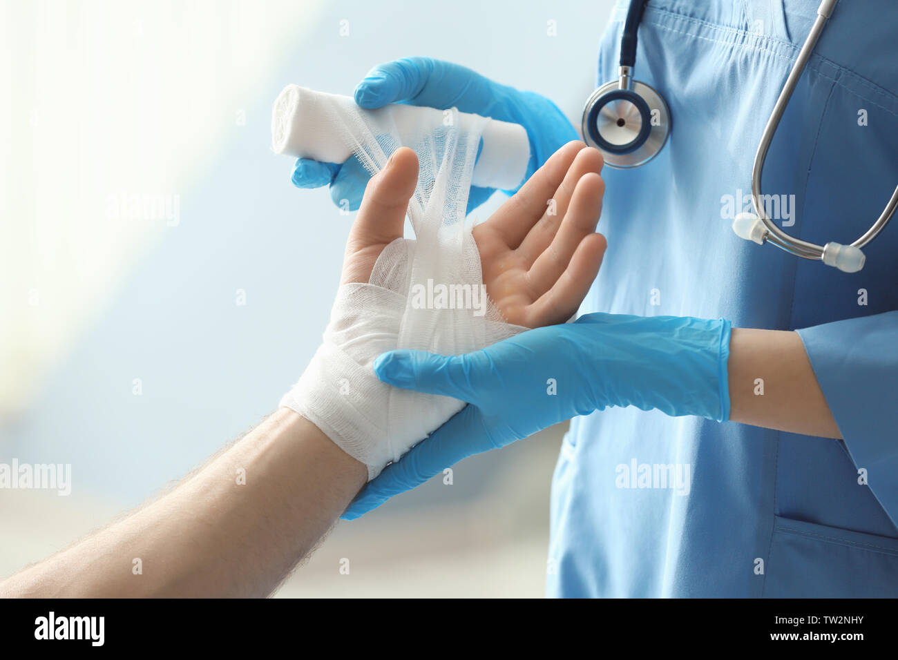 Doctor Applying Bandage To Patients Hand And Wrist High Resolution ...