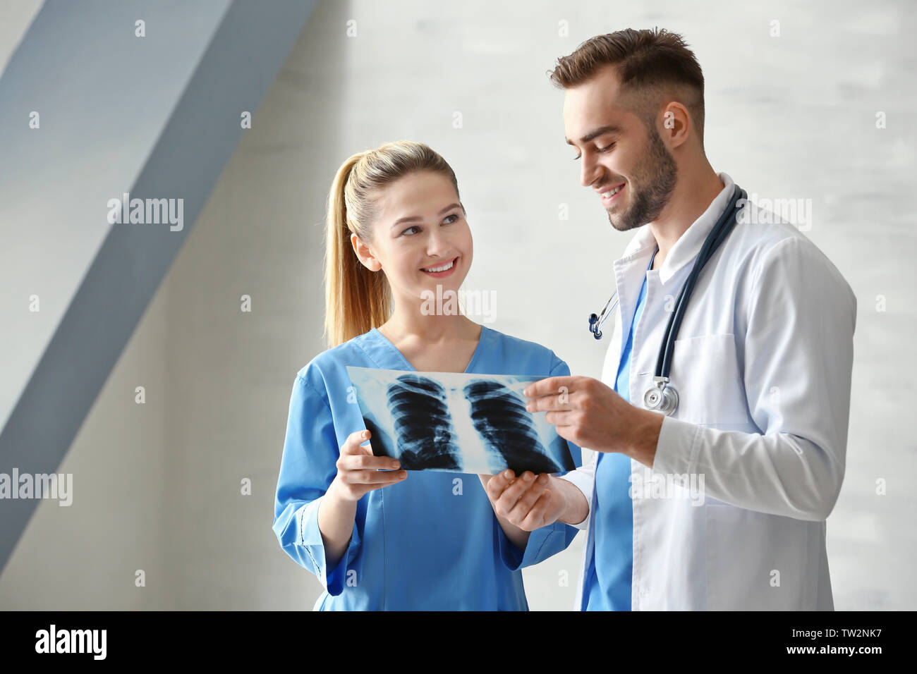 Doctor and medical assistant discussing x-ray image in office Stock ...