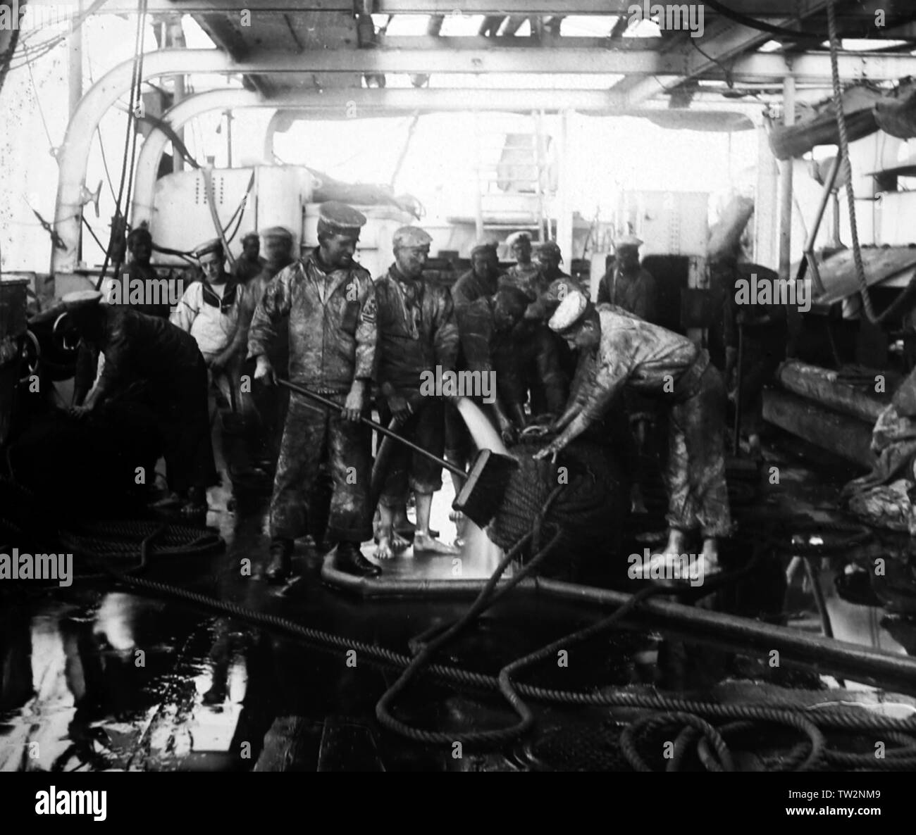 British Navy sailors tarring rope Stock Photo - Alamy