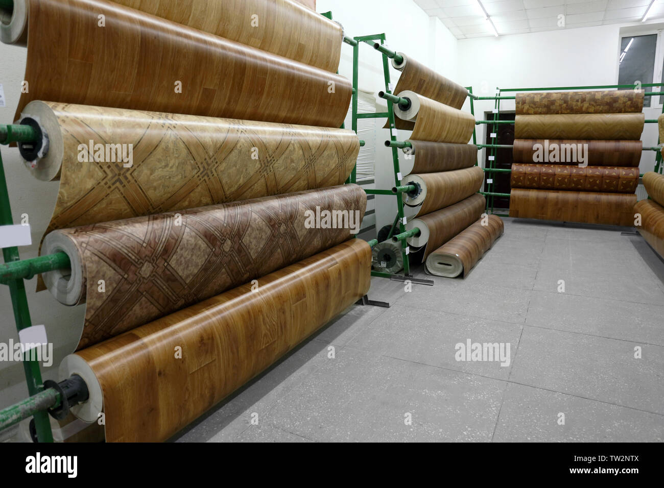 Racks with linoleum rolls in wholesale warehouse Stock Photo - Alamy