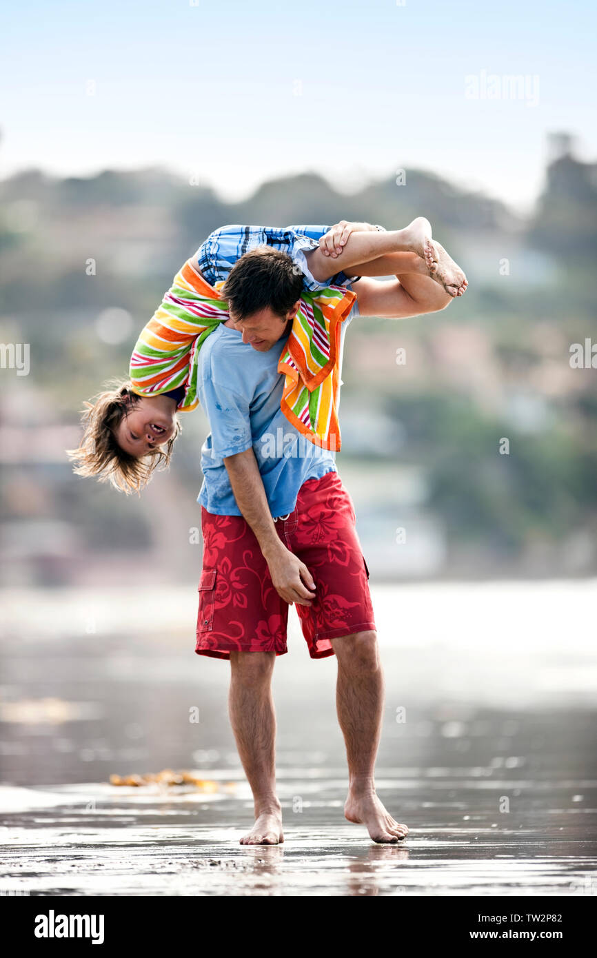 Father carrying son over shoulder hi-res stock photography and images ...