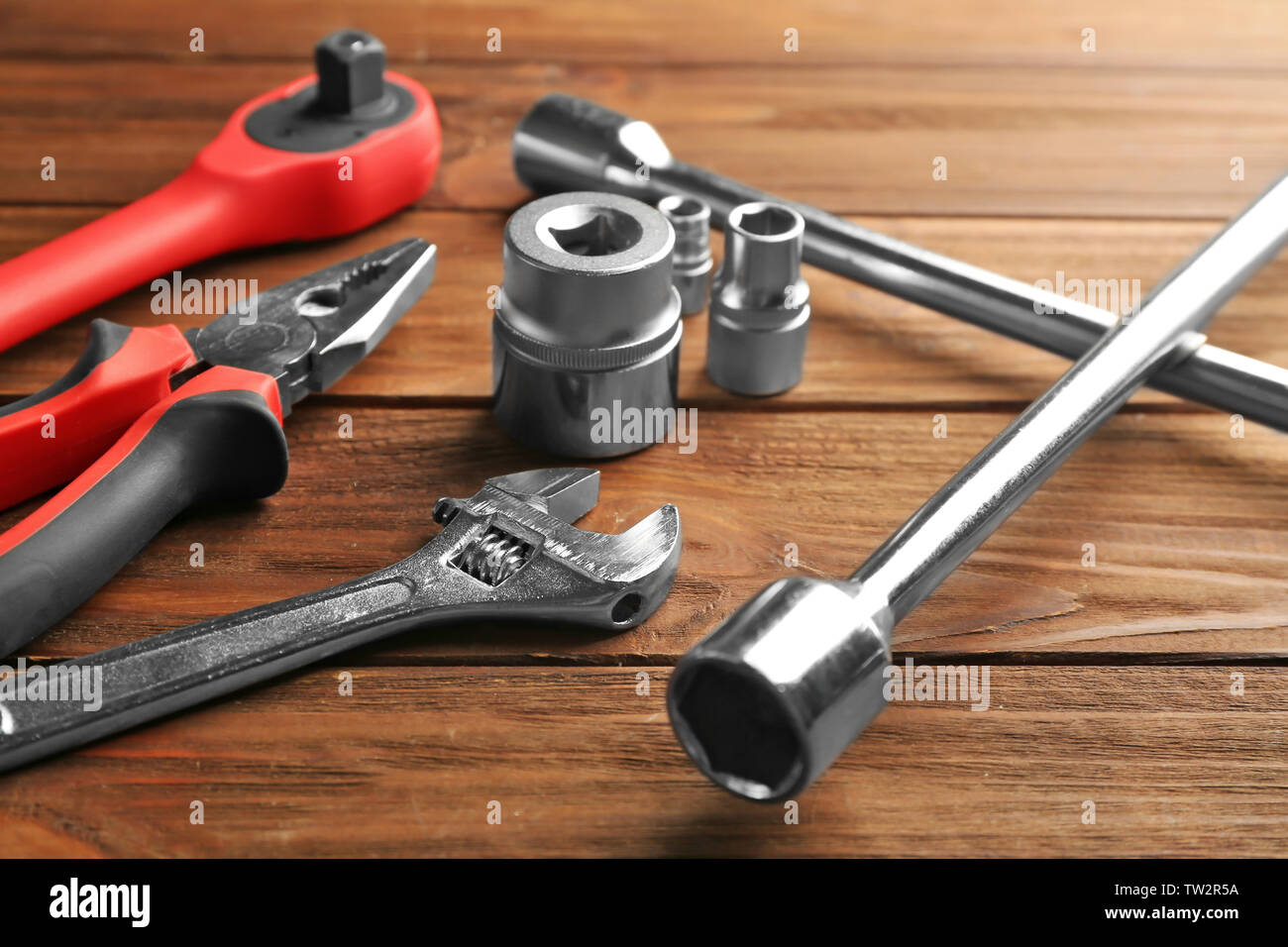Setting of tools for car repair on wooden background Stock Photo - Alamy