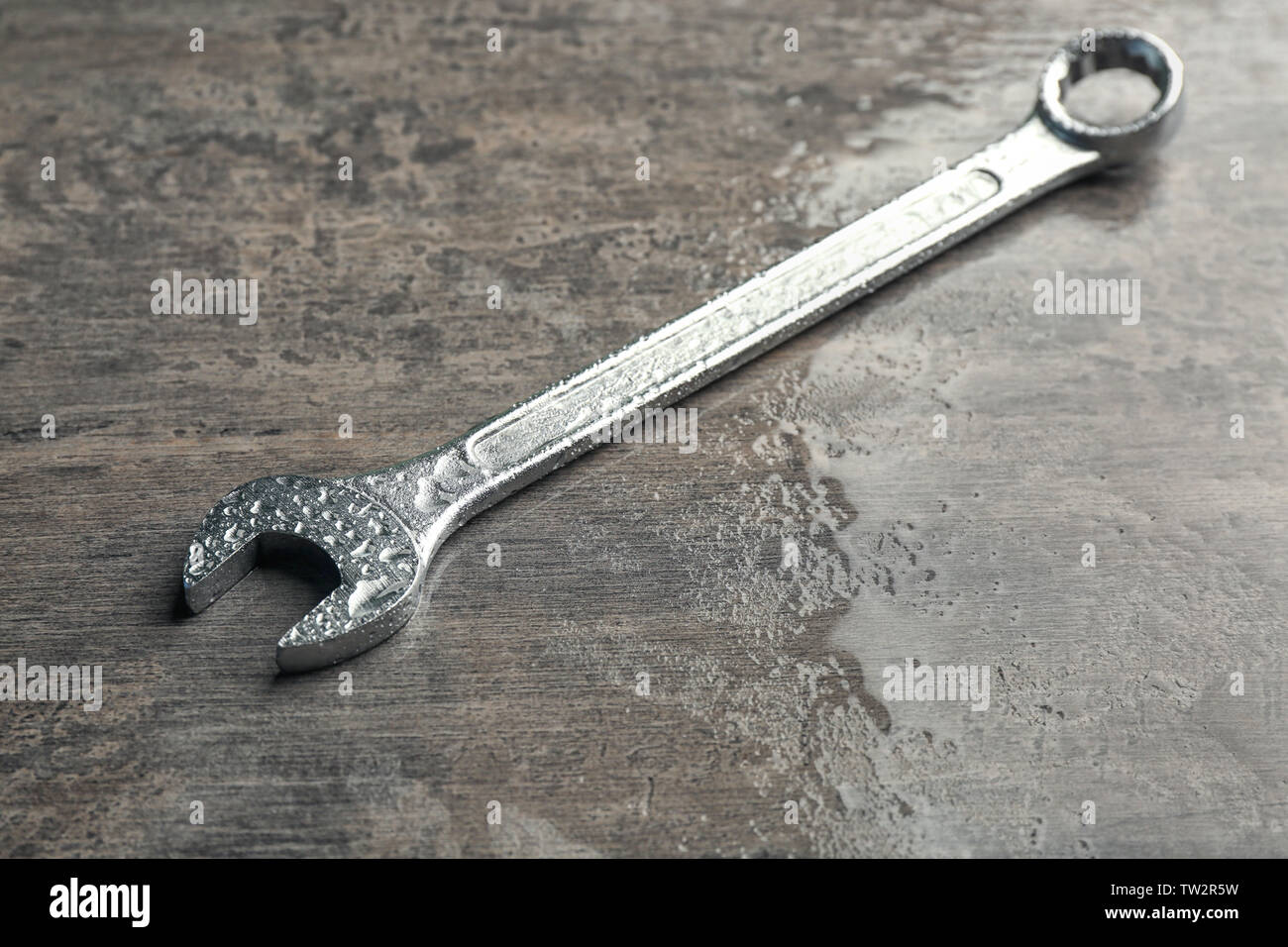 Combination wrench on wet table Stock Photo - Alamy