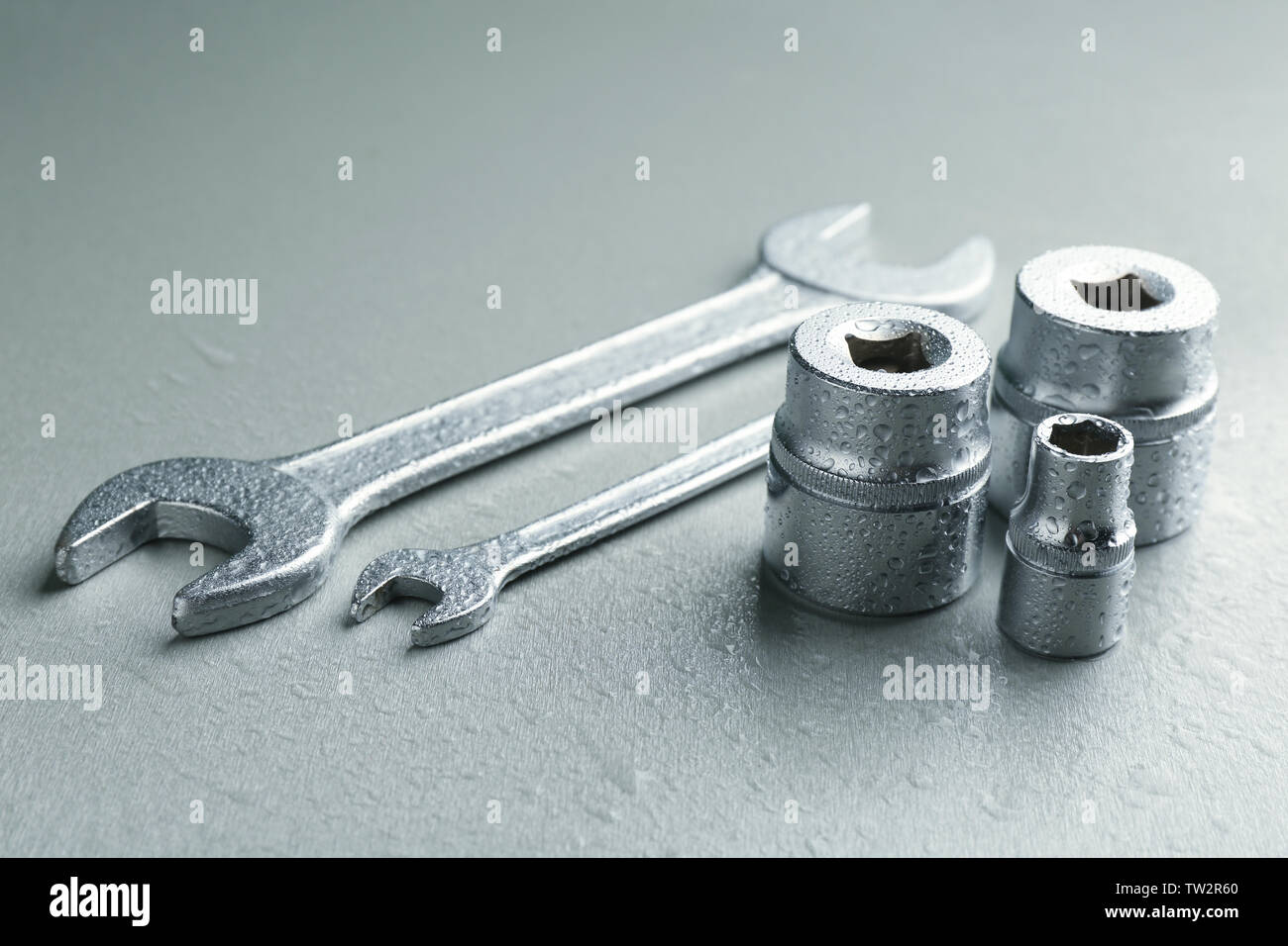 Hand sockets and spanners on light background Stock Photo - Alamy