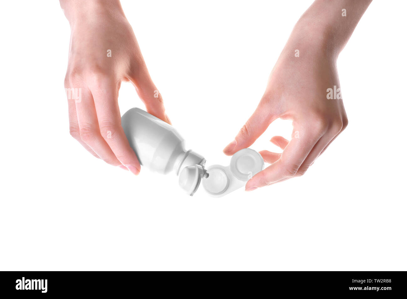 Female hands adding solution to lens container on white background ...