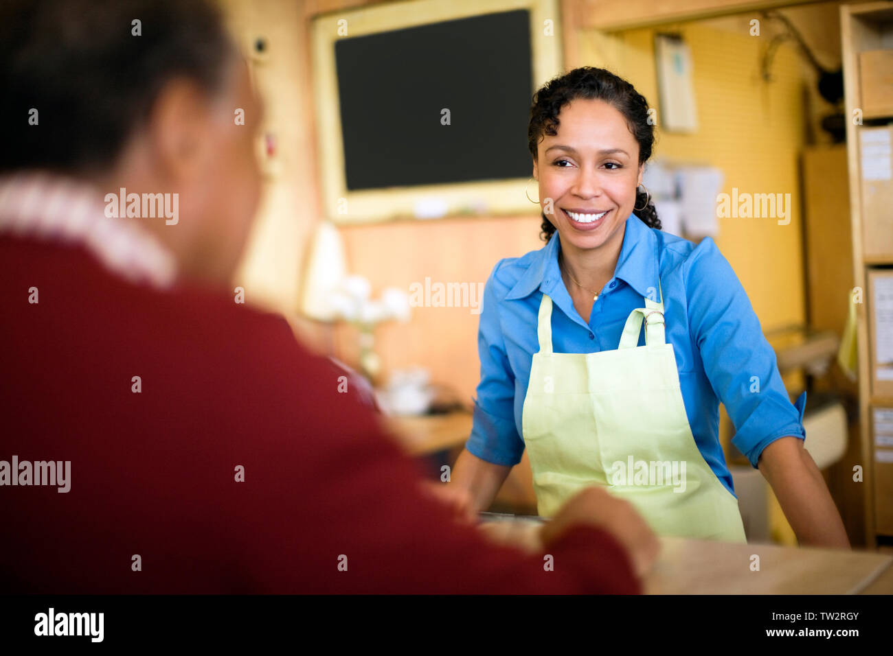 Sales clerk and customer in store Stock Photo - Alamy