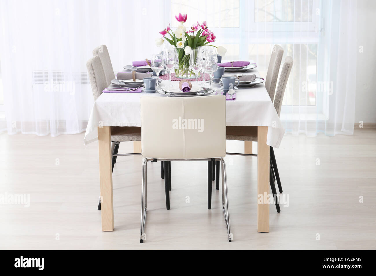 Table with beautiful setting in restaurant Stock Photo - Alamy