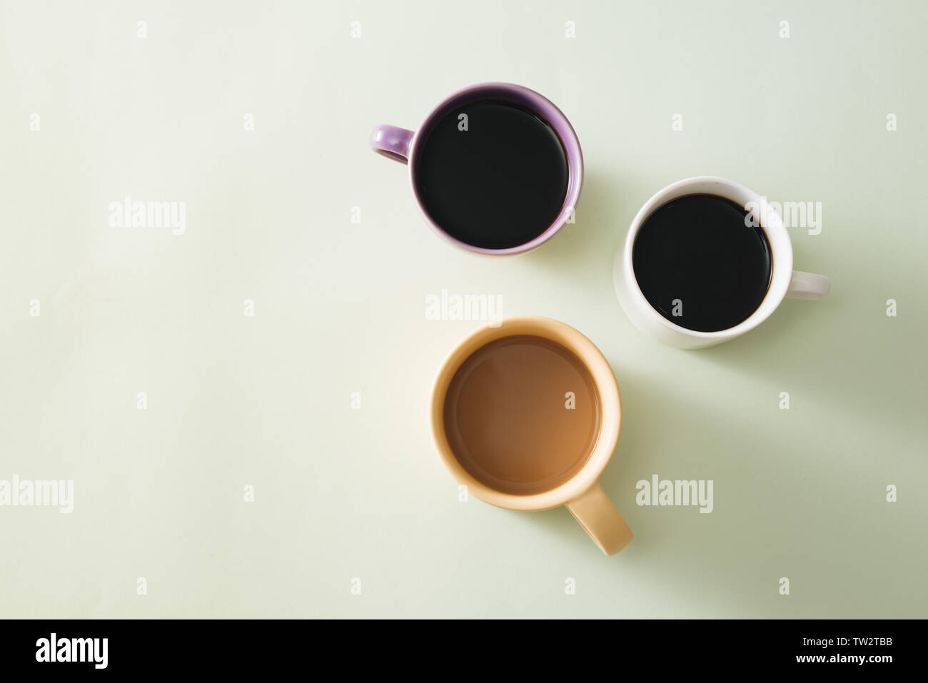 Cups of coffee on light background Stock Photo - Alamy