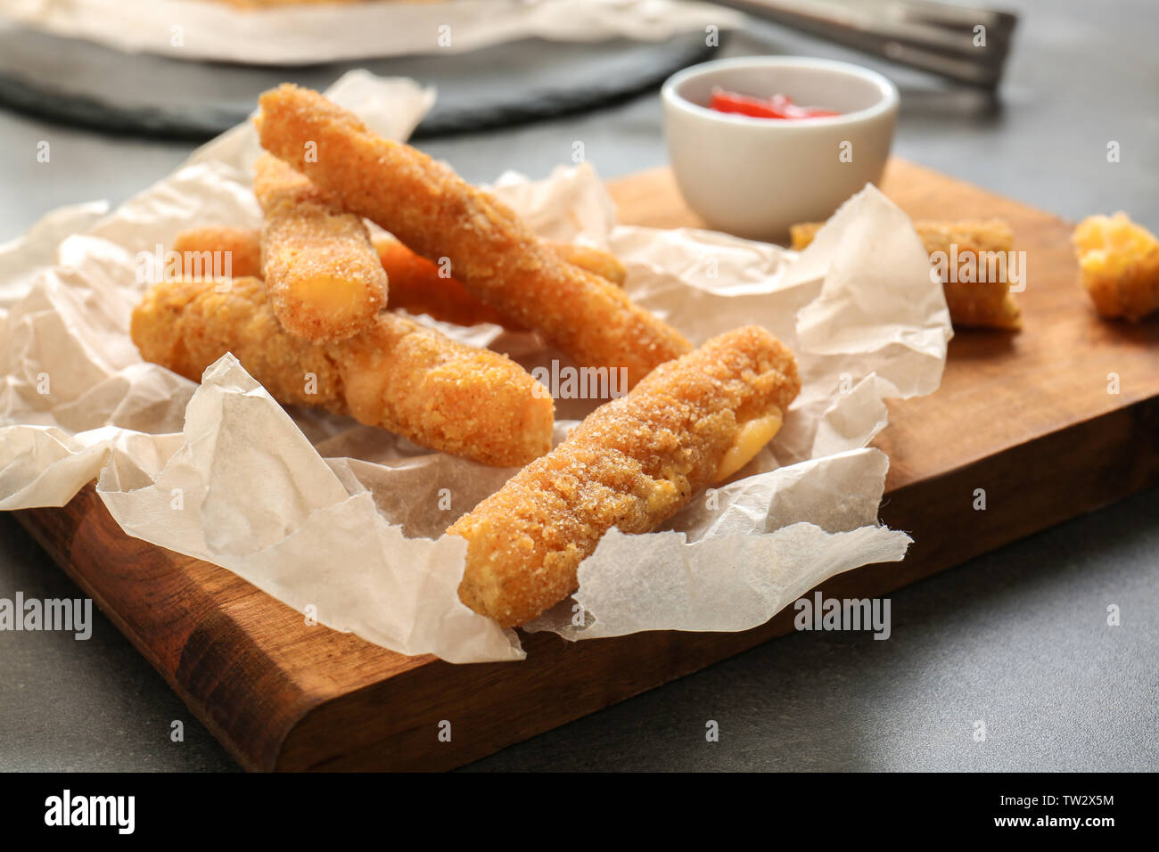 Delicious fried cheese sticks on food paper Stock Photo - Alamy