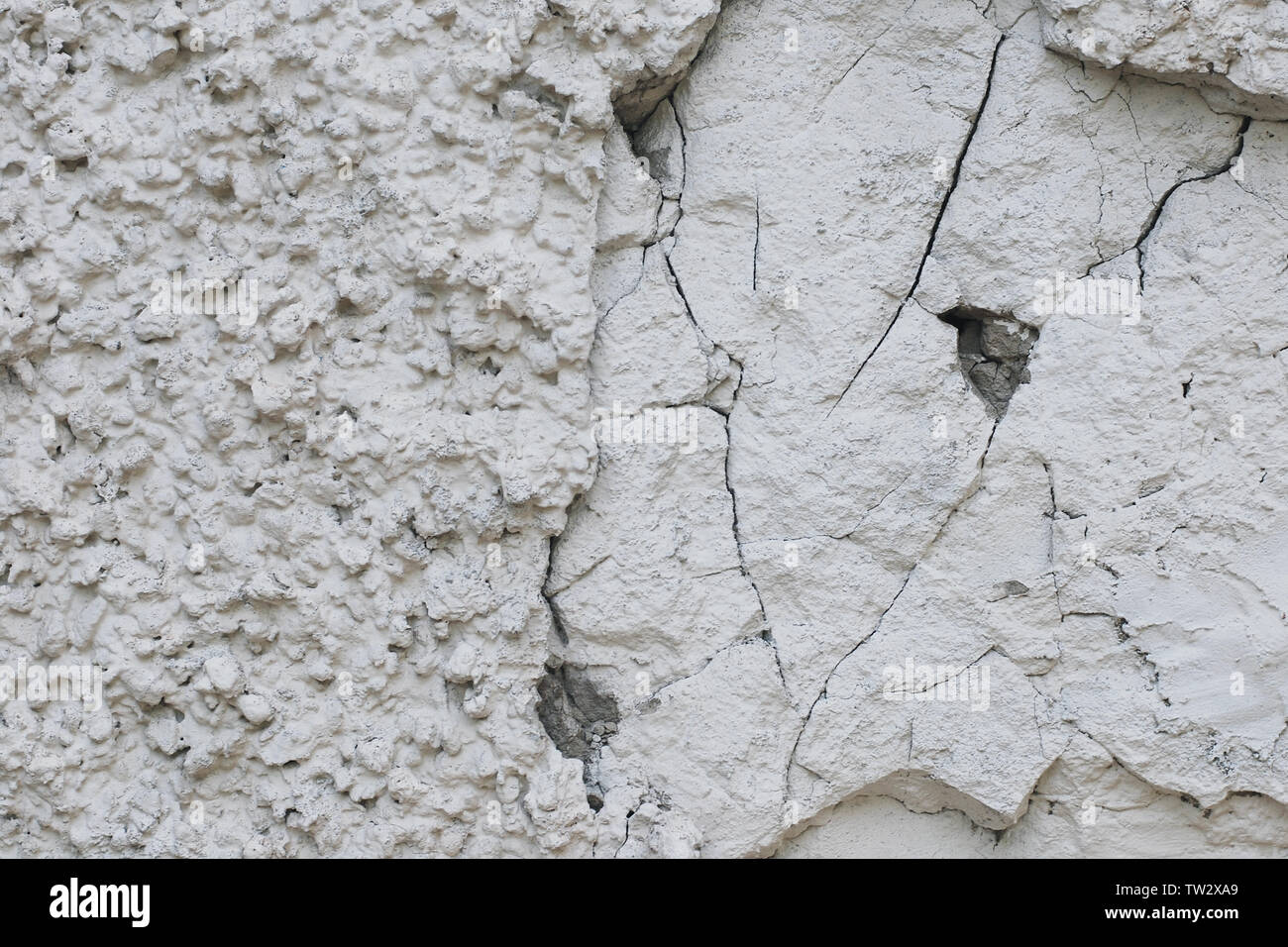 Extremely rough grungy texture of white plastered stone wall, half ...