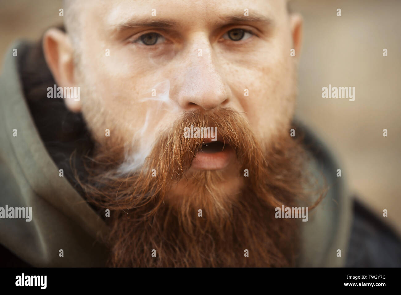 Bearded man smoking weed outdoors, closeup Stock Photo - Alamy