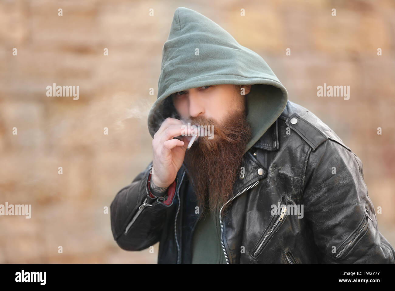 Bearded man smoking weed outdoors Stock Photo - Alamy