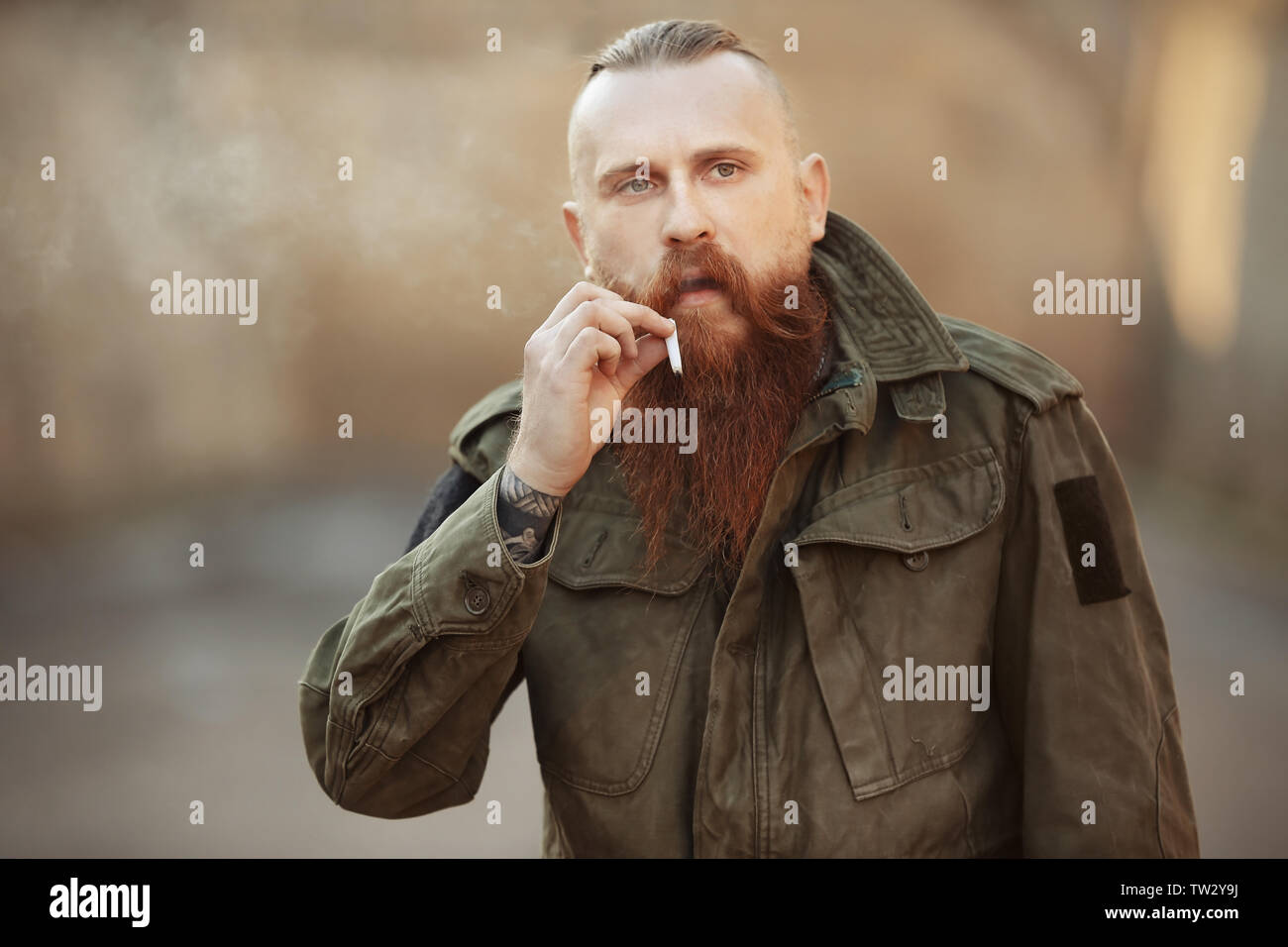 Bearded man smoking weed outdoors Stock Photo - Alamy