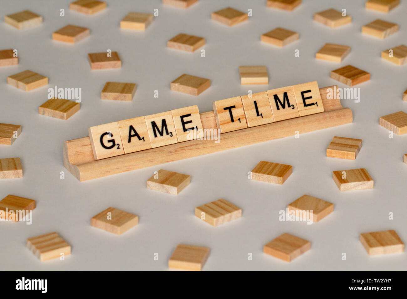 Scrabble Word Game wood tiles spelling "Game Time Stock Photo - Alamy