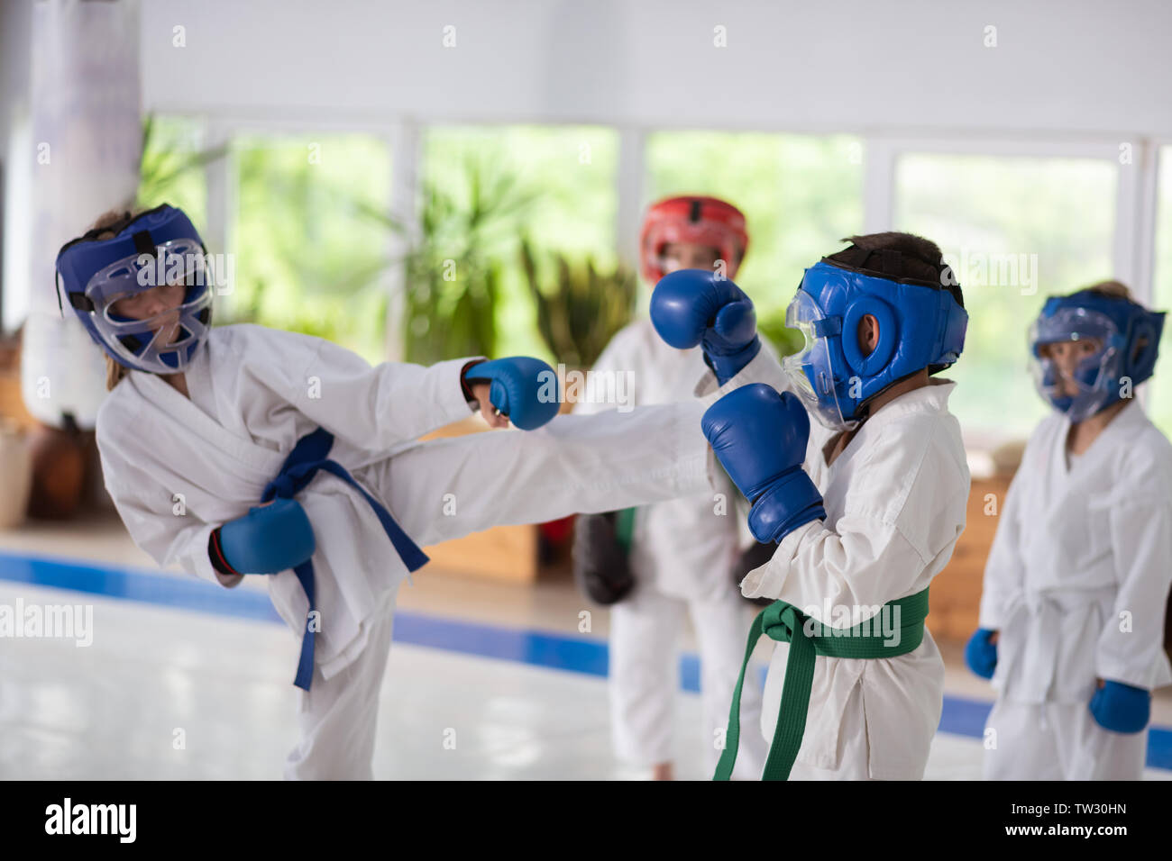 Girl raising leg. Girl wearing white kimono raising her leg while ...