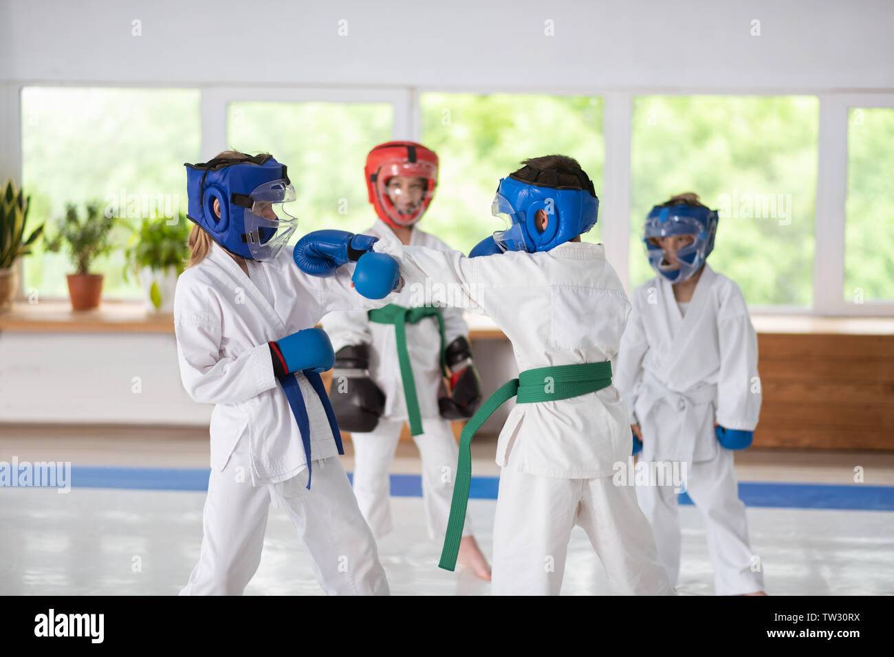 Attacking each other. Boy and girl in white kimono attacking each other ...