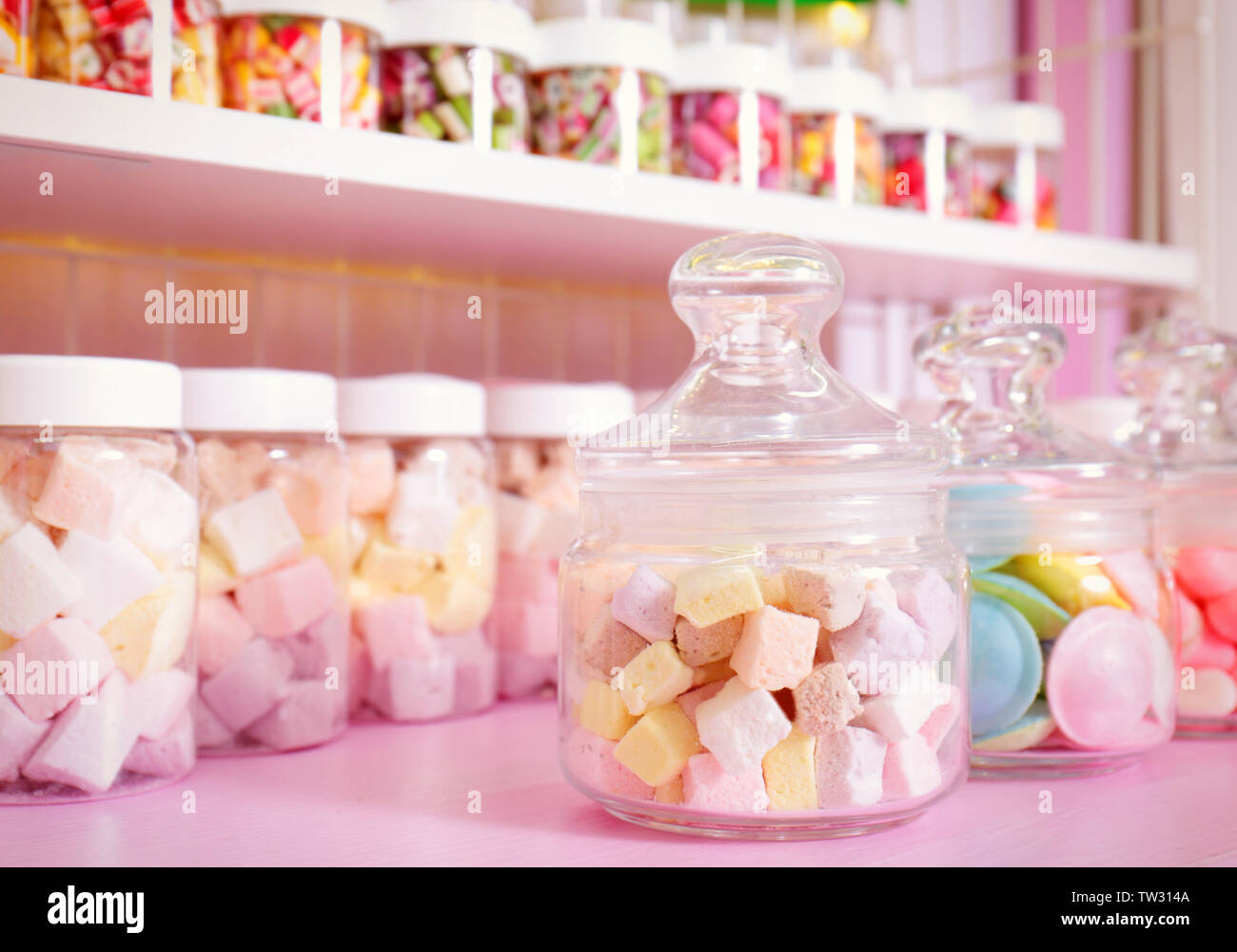 Different sweets in jars at candy shop Stock Photo - Alamy