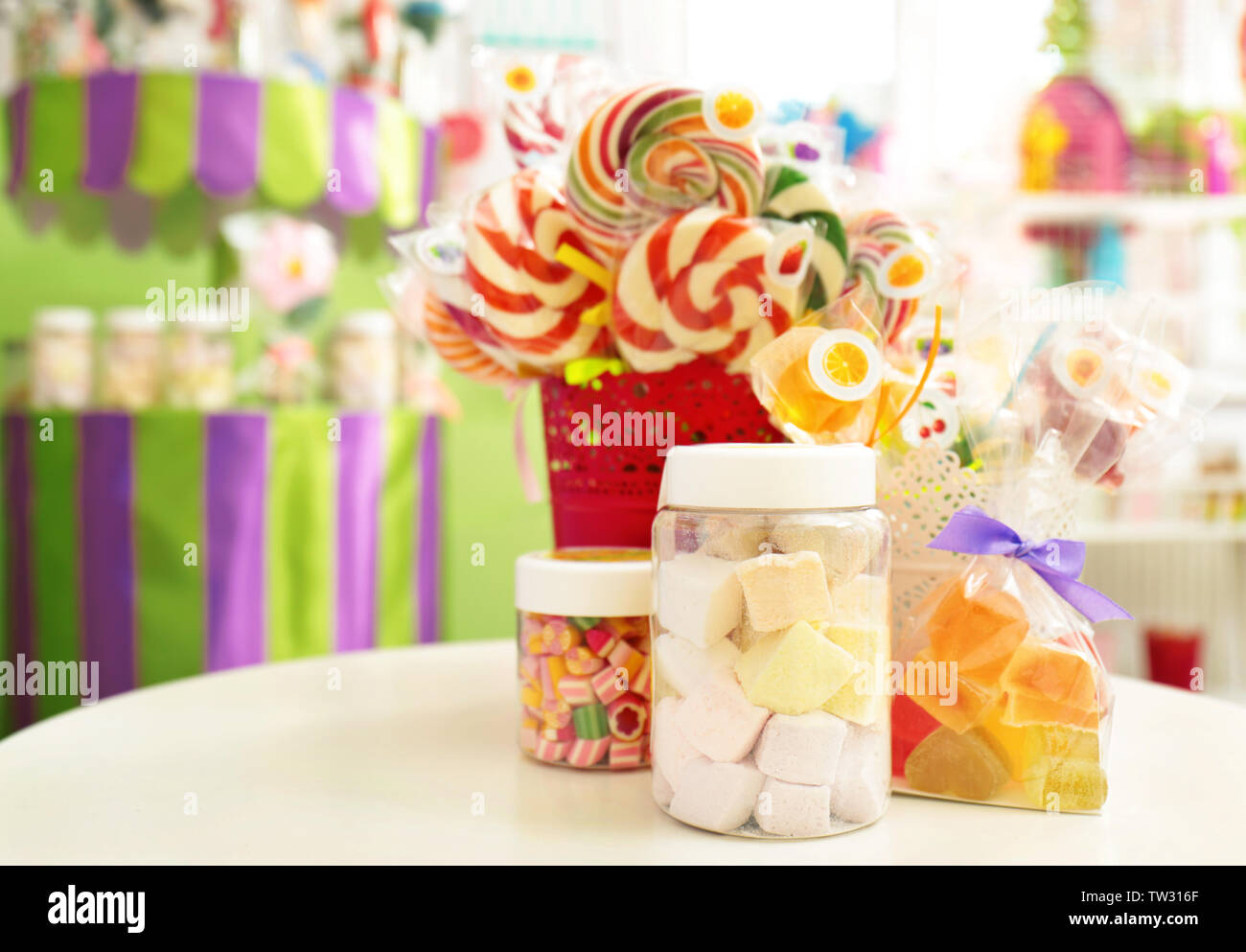 Different sweets on table at candy shop Stock Photo - Alamy