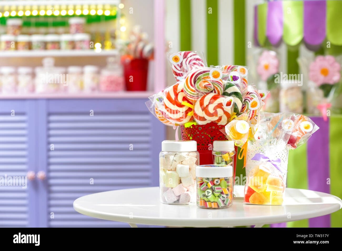 Different sweets on table at candy shop Stock Photo - Alamy
