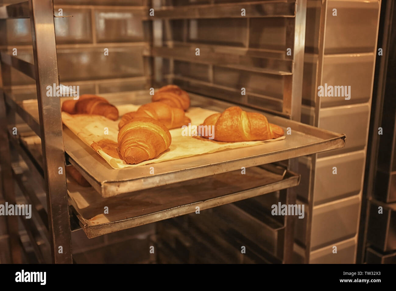 Rack with pastry on trays in bakery Stock Photo - Alamy