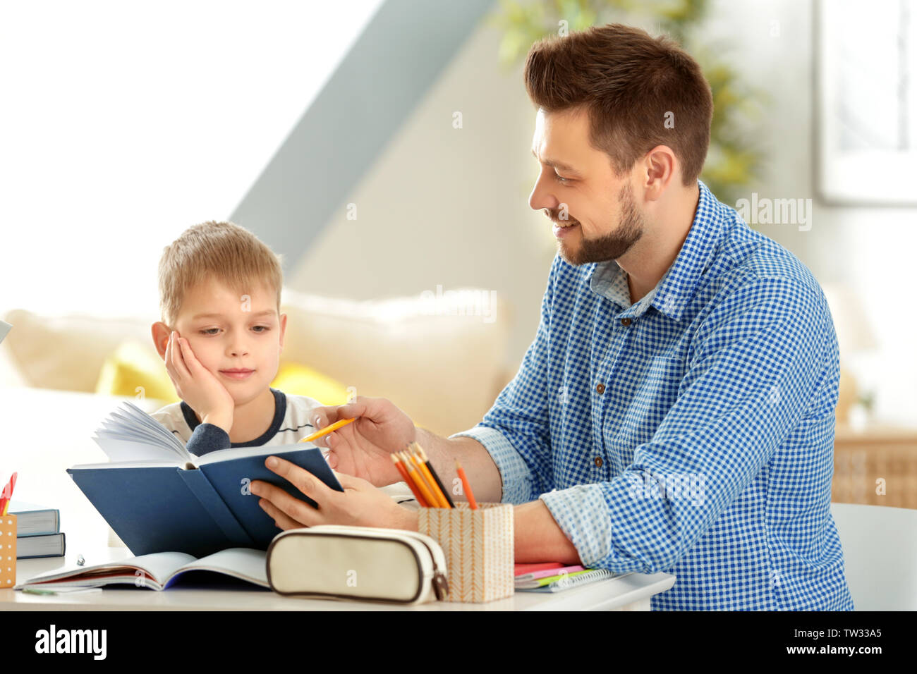 Father and son doing homework together at home Stock Photo - Alamy