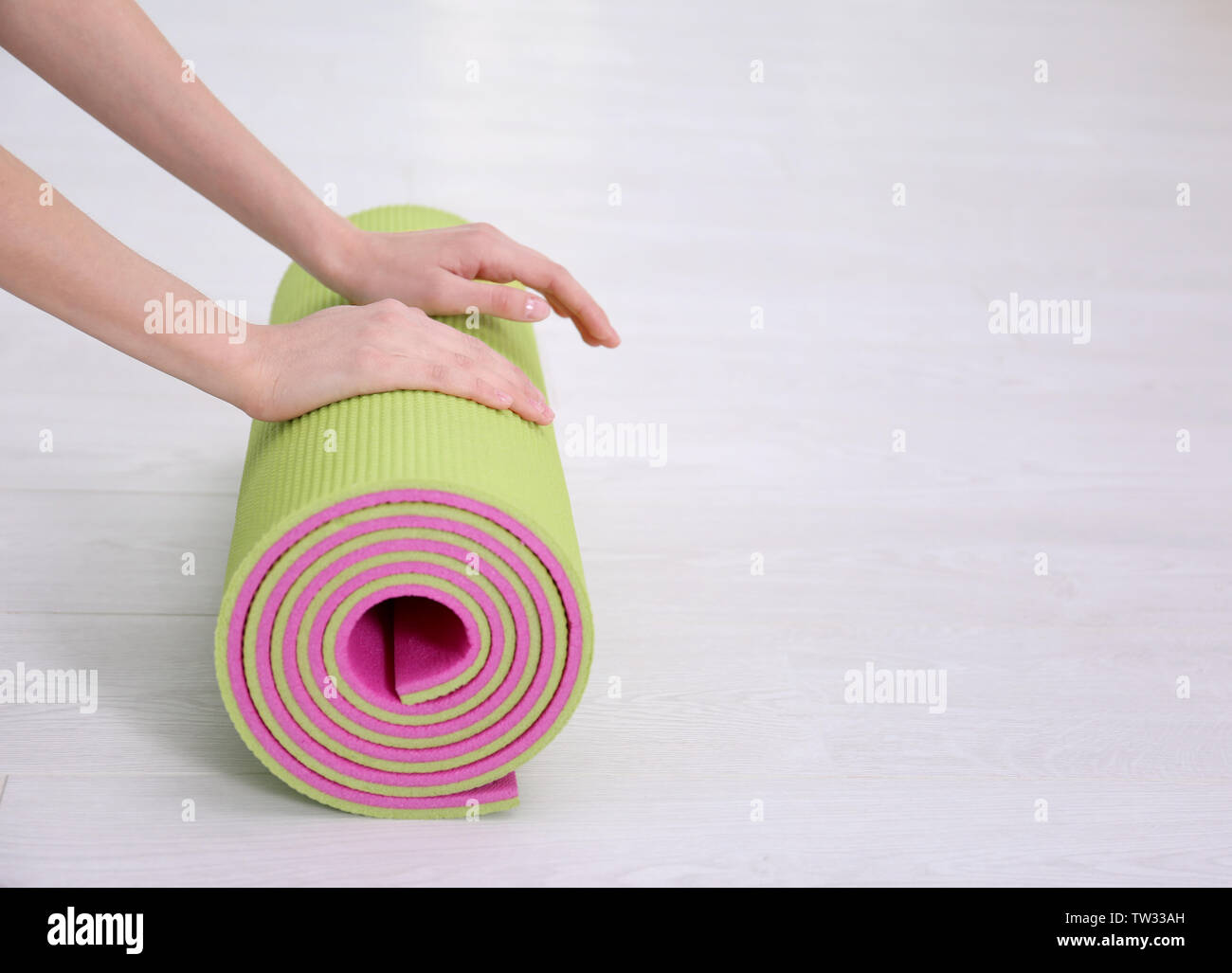 Rolling up yoga mat hi-res stock photography and images - Alamy