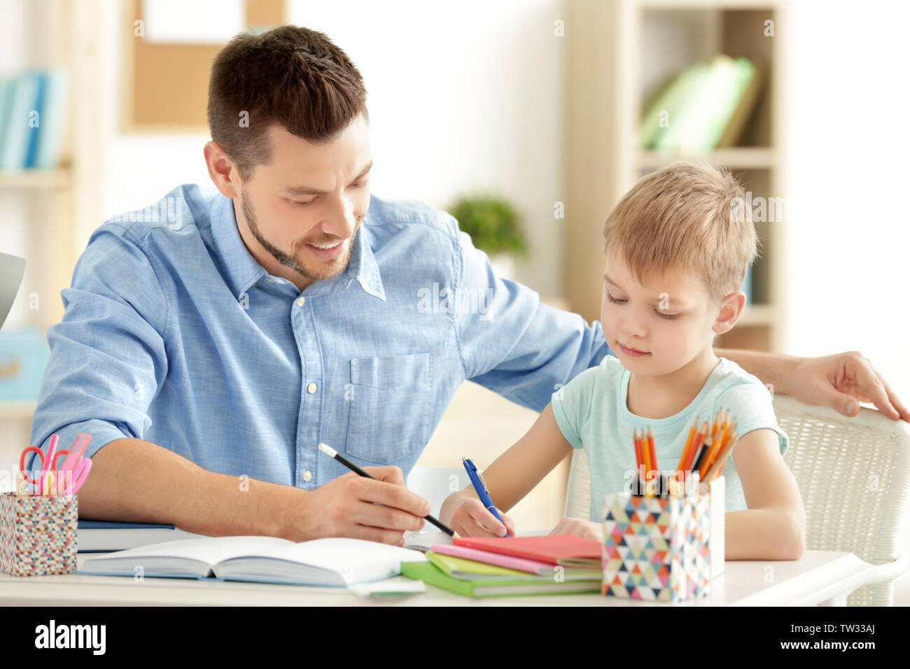 Father and son doing homework together at home Stock Photo - Alamy