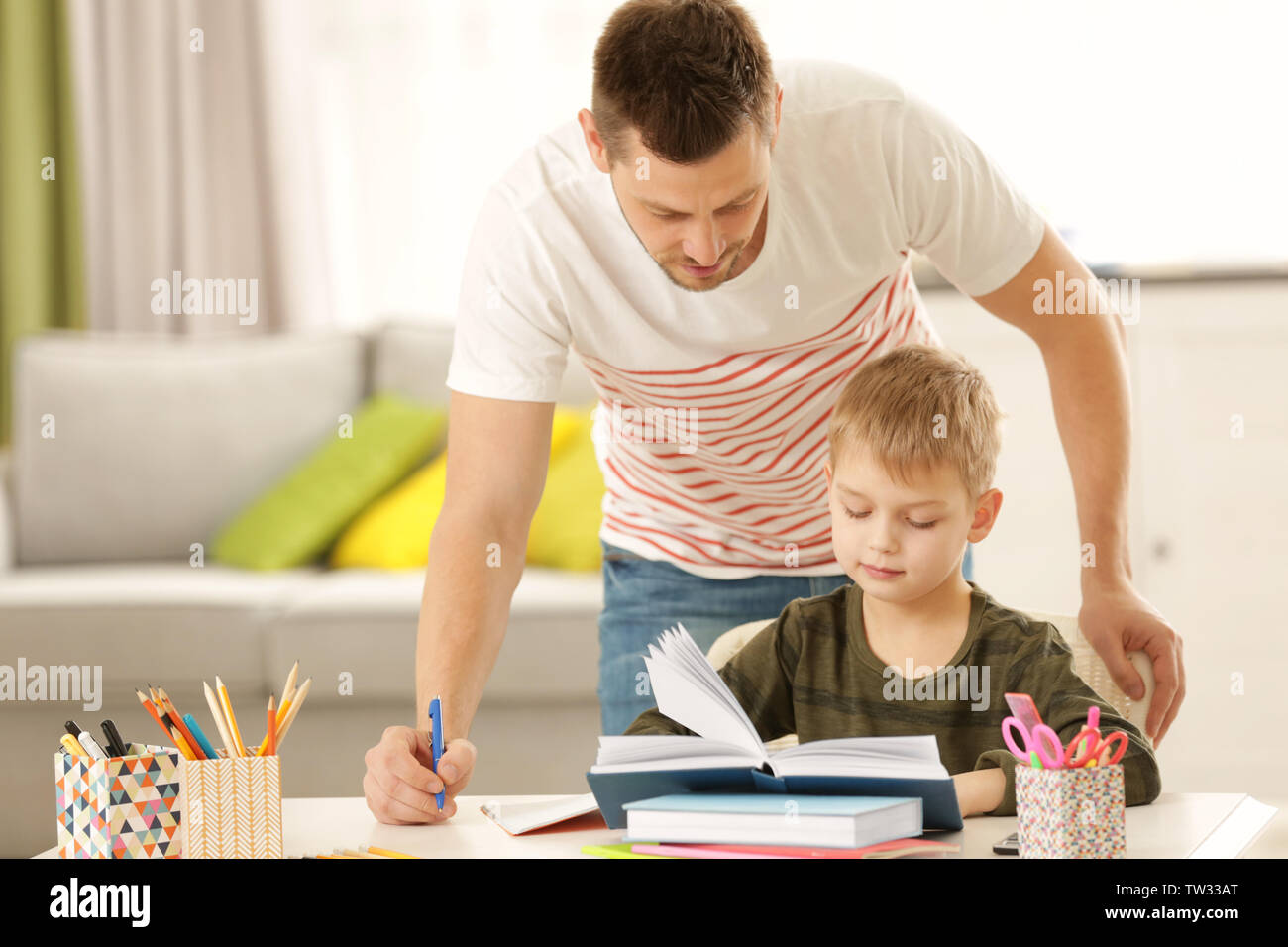 Father and son doing homework together at home Stock Photo - Alamy