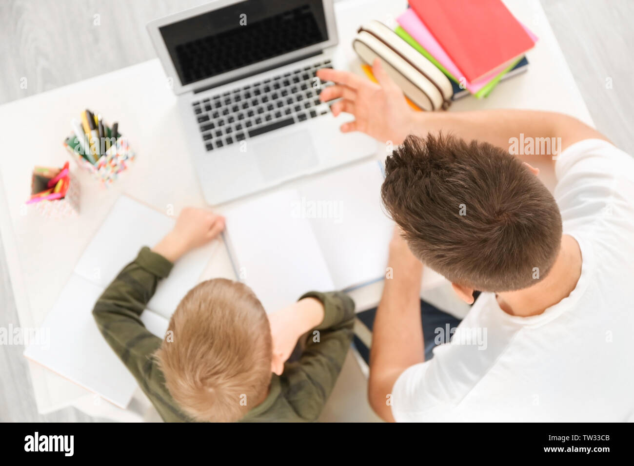 Father and son doing homework together at home Stock Photo - Alamy