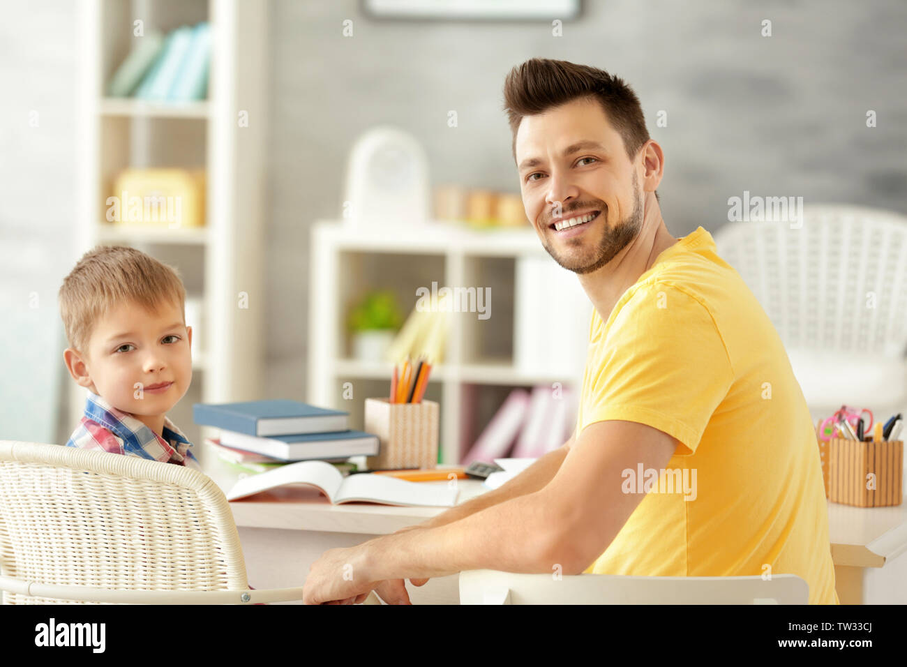 Father and son doing homework together at home Stock Photo - Alamy