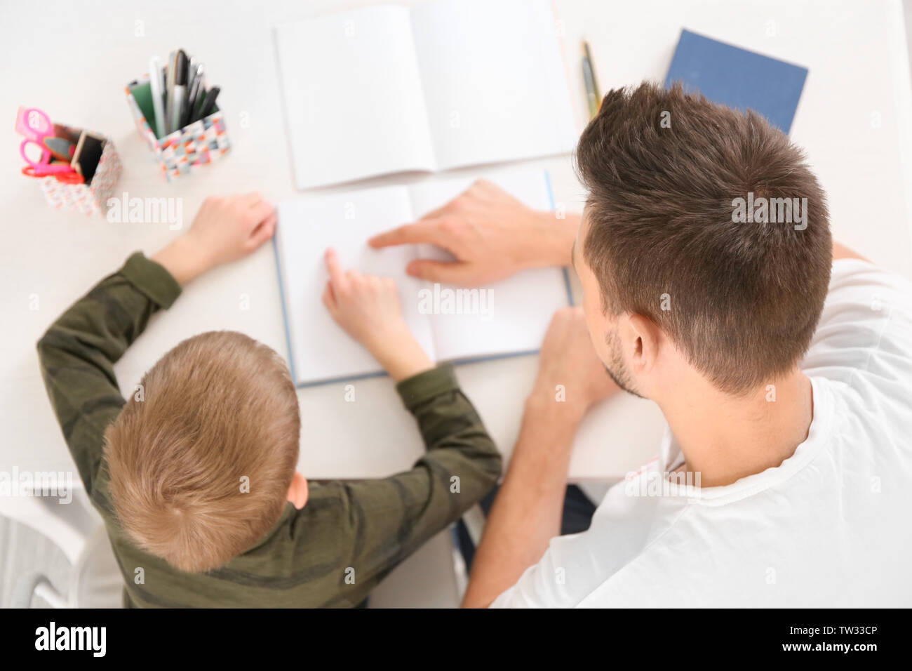 Father and son doing homework together at home Stock Photo - Alamy