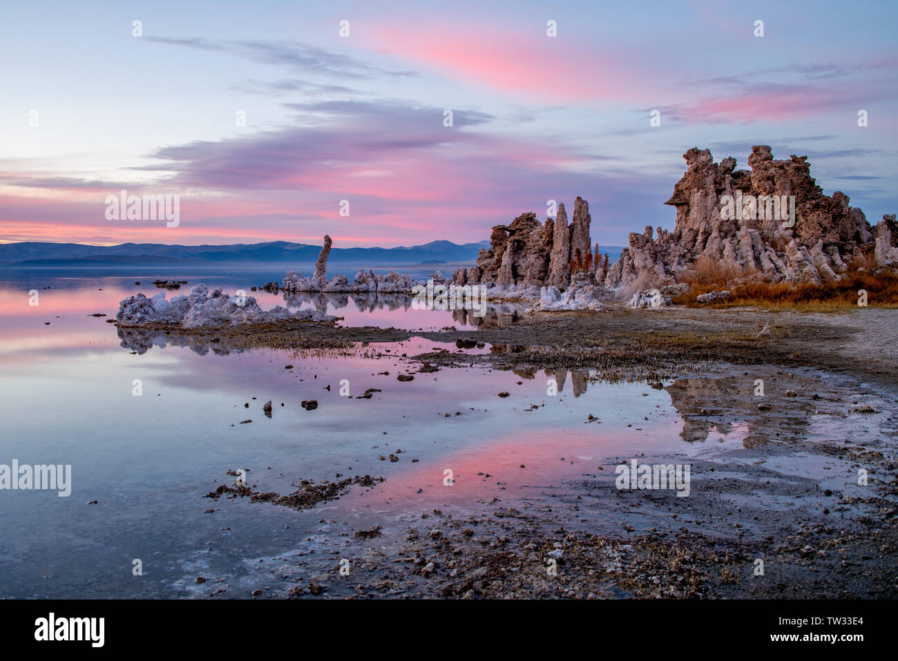 Ancient lake in a crater of an extinct volcano. Tufa stalactites are ...