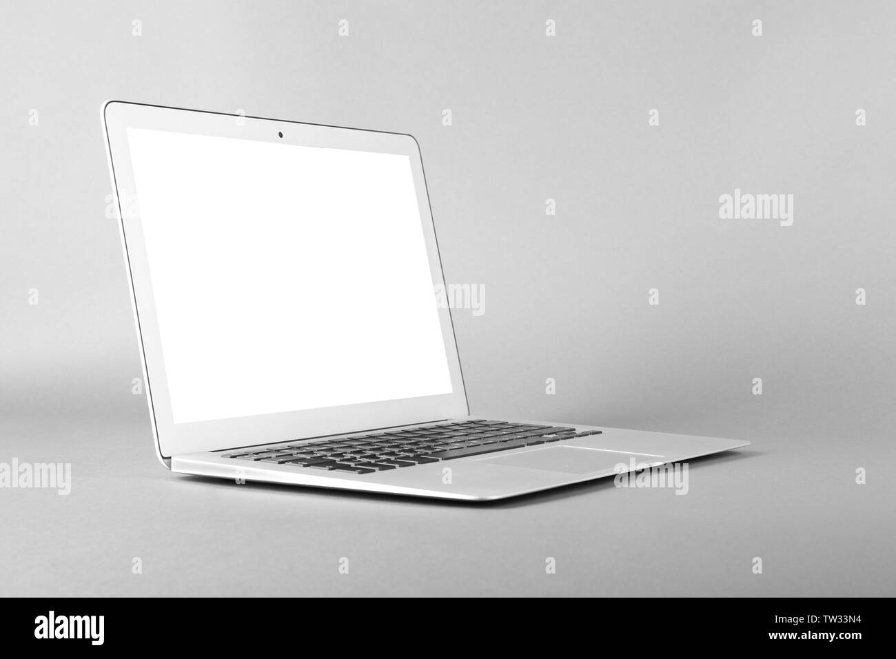 Modern laptop on gray background Stock Photo - Alamy