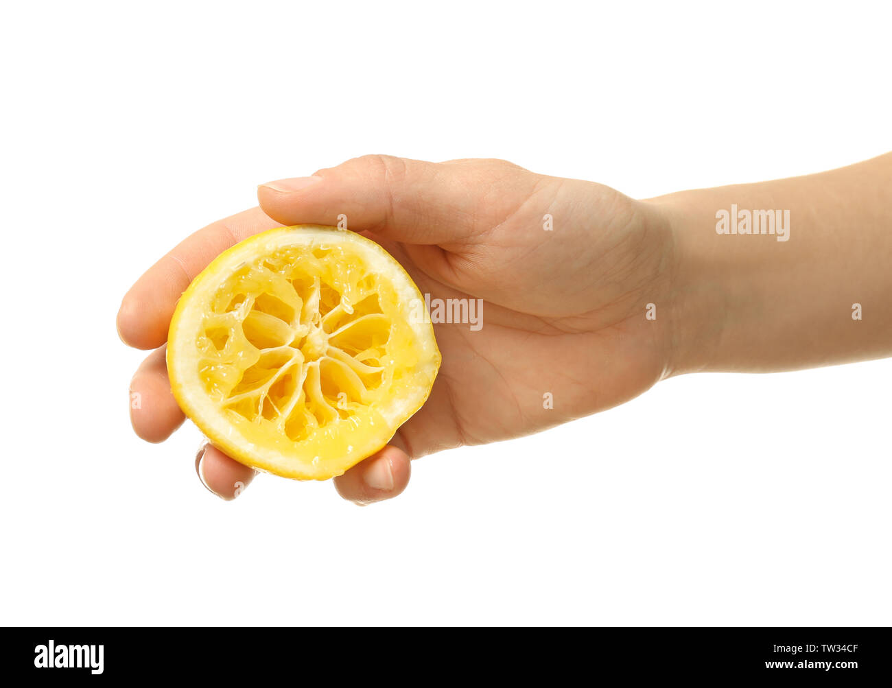 Female hand holding half of lemon on white background Stock Photo - Alamy