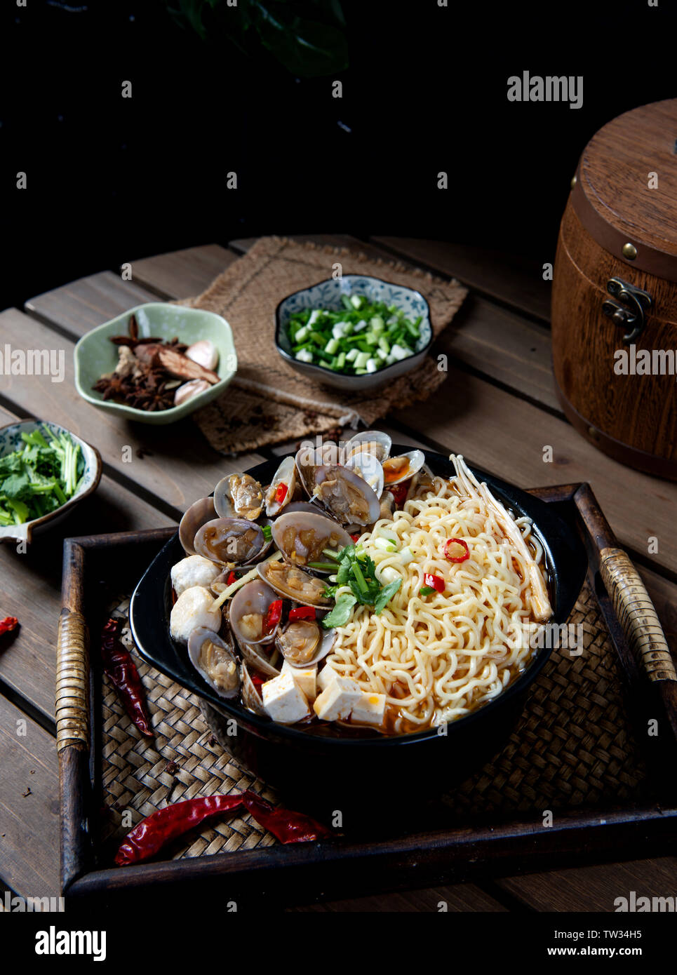 Golden soup, spicy flower armor, pink noodles Stock Photo - Alamy