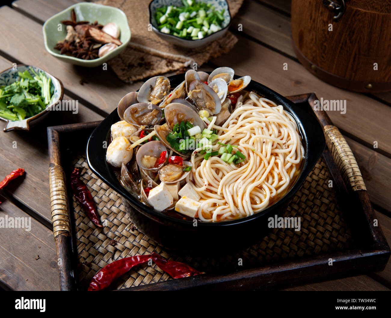 Golden soup, spicy flower armor, pink noodles Stock Photo - Alamy