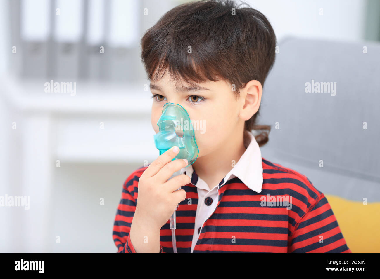 Boy using asthma machine at home Stock Photo - Alamy