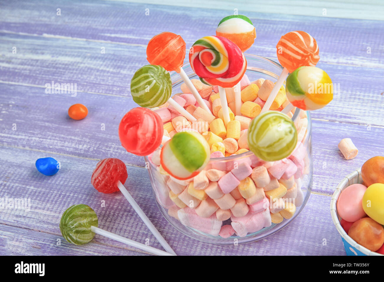 Composition with tasty candies on table Stock Photo - Alamy