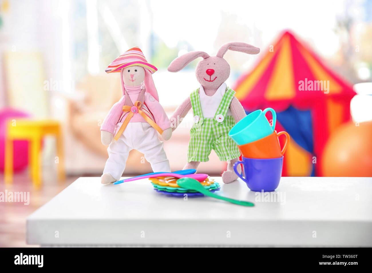Cute toys on table in baby room Stock Photo - Alamy