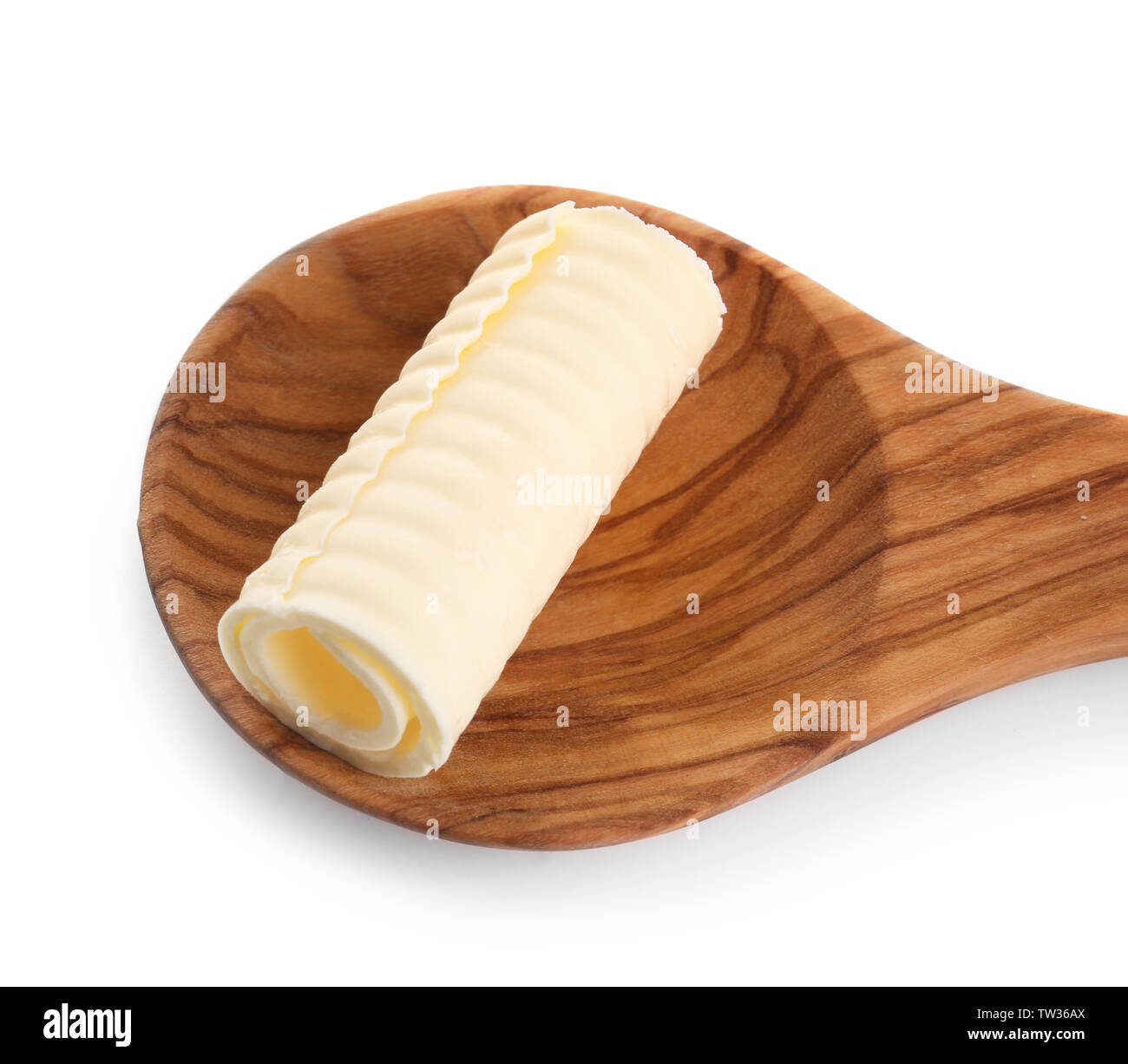 Delicious butter curl in wooden spoon on white background, closeup ...