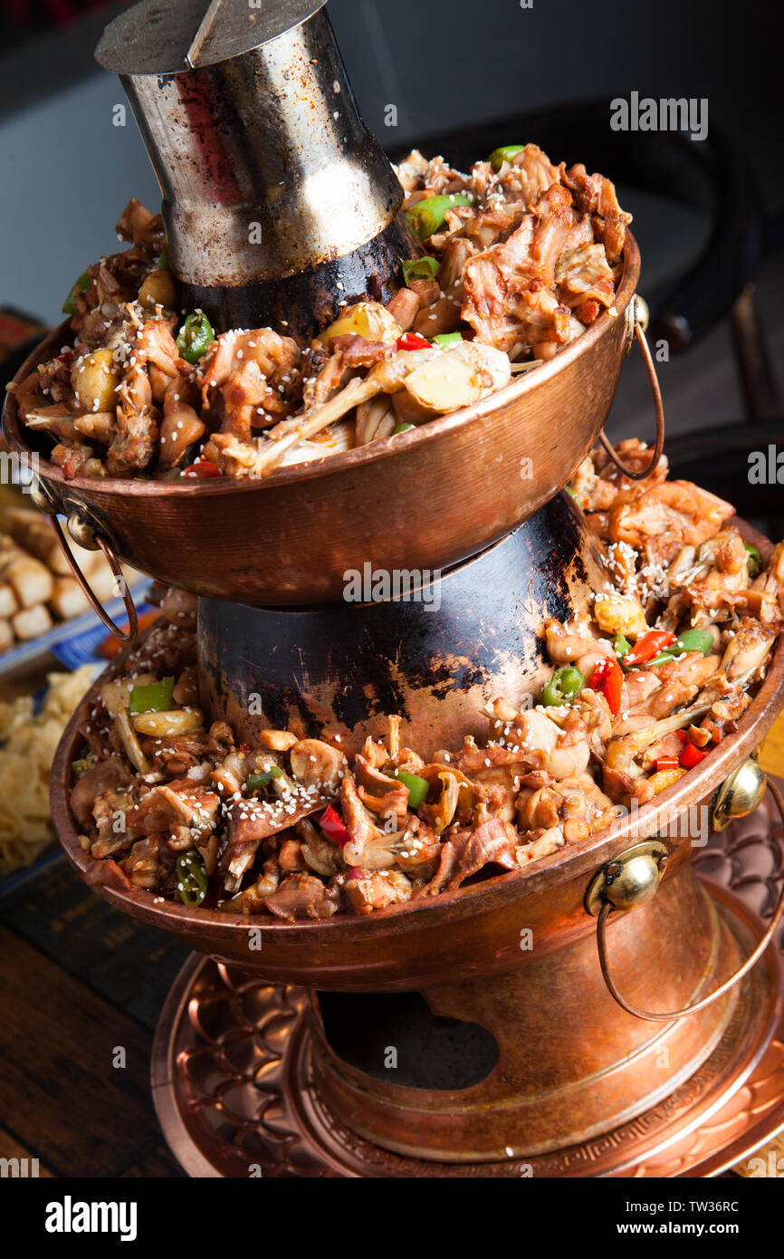 Charcoal fire frog pot field chicken meal Stock Photo - Alamy