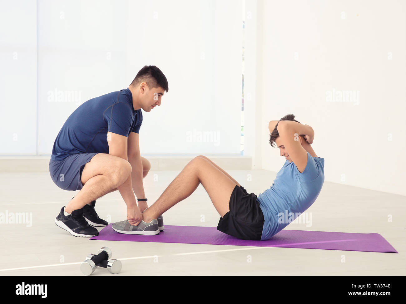 Dad and son training in gym Stock Photo - Alamy