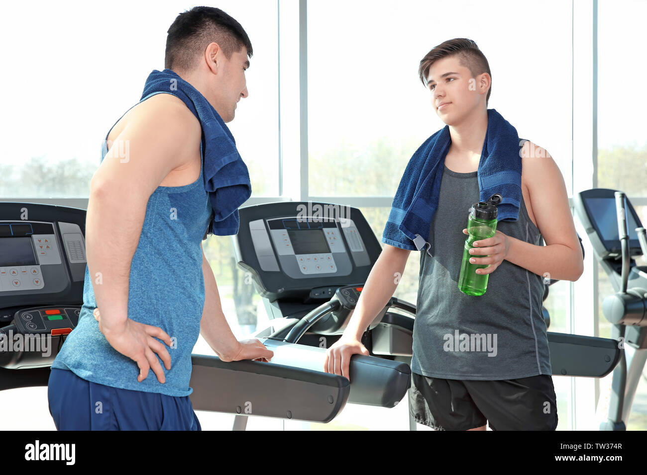 Dad and son training in modern gym Stock Photo - Alamy