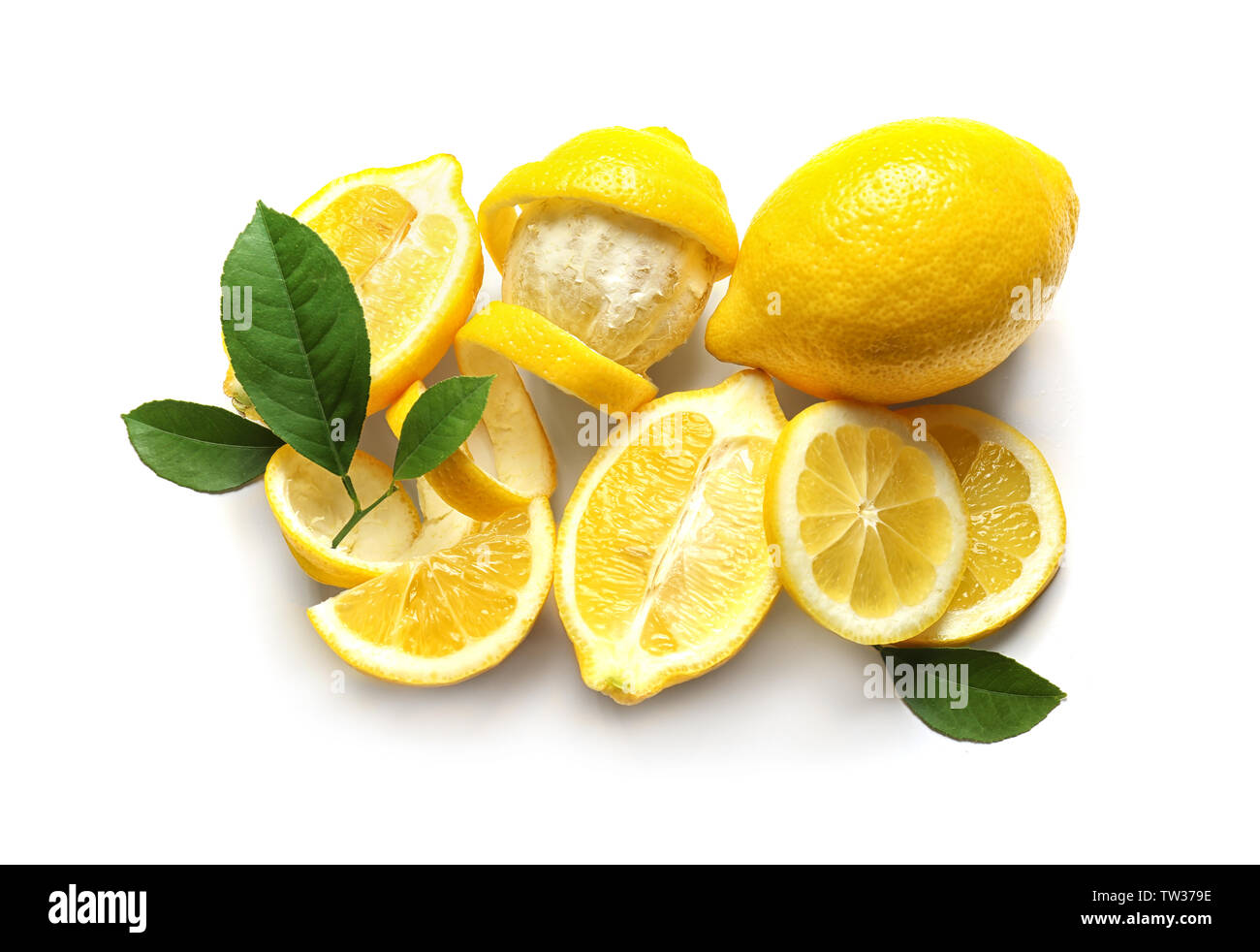 Delicious sliced and peeled lemons with green leaves on white ...