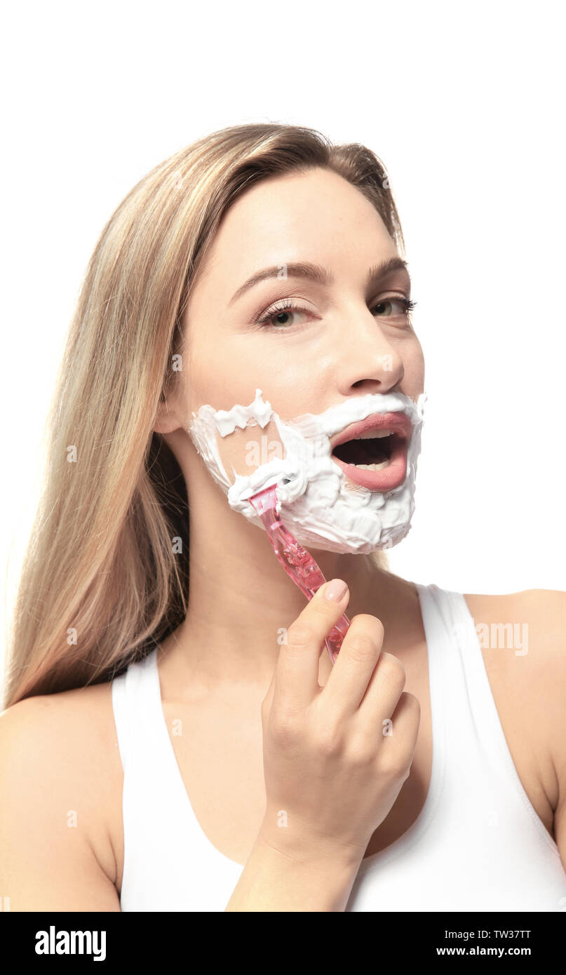 Young woman shaving face on white background Stock Photo - Alamy