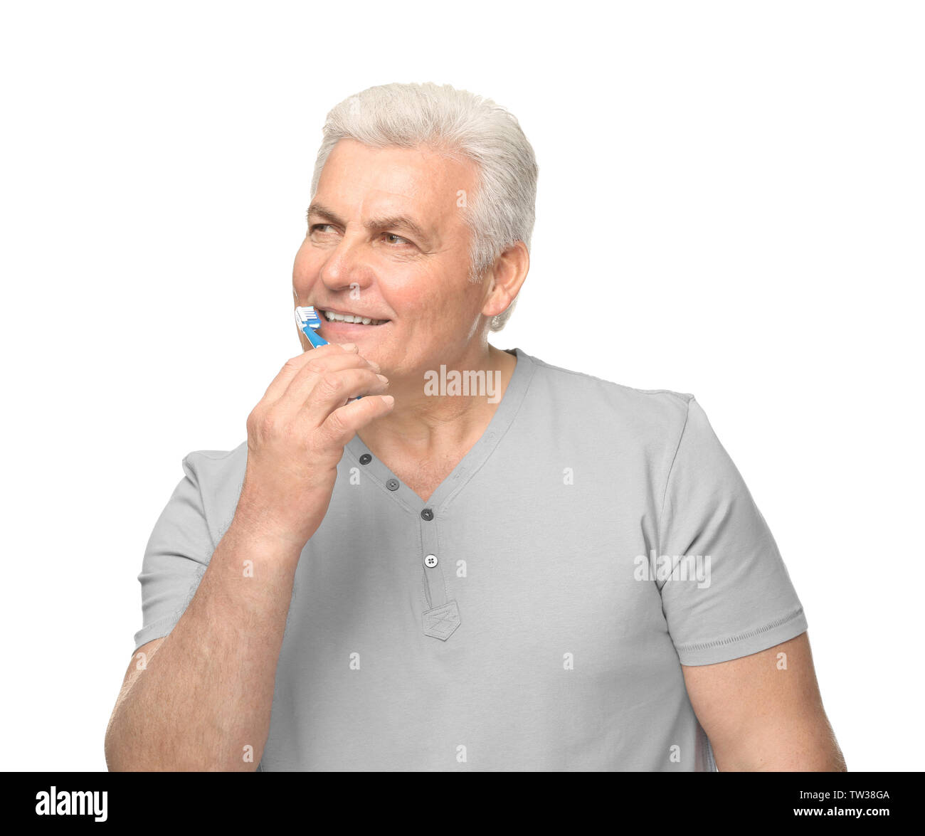 Senior man cleaning teeth on white background Stock Photo - Alamy