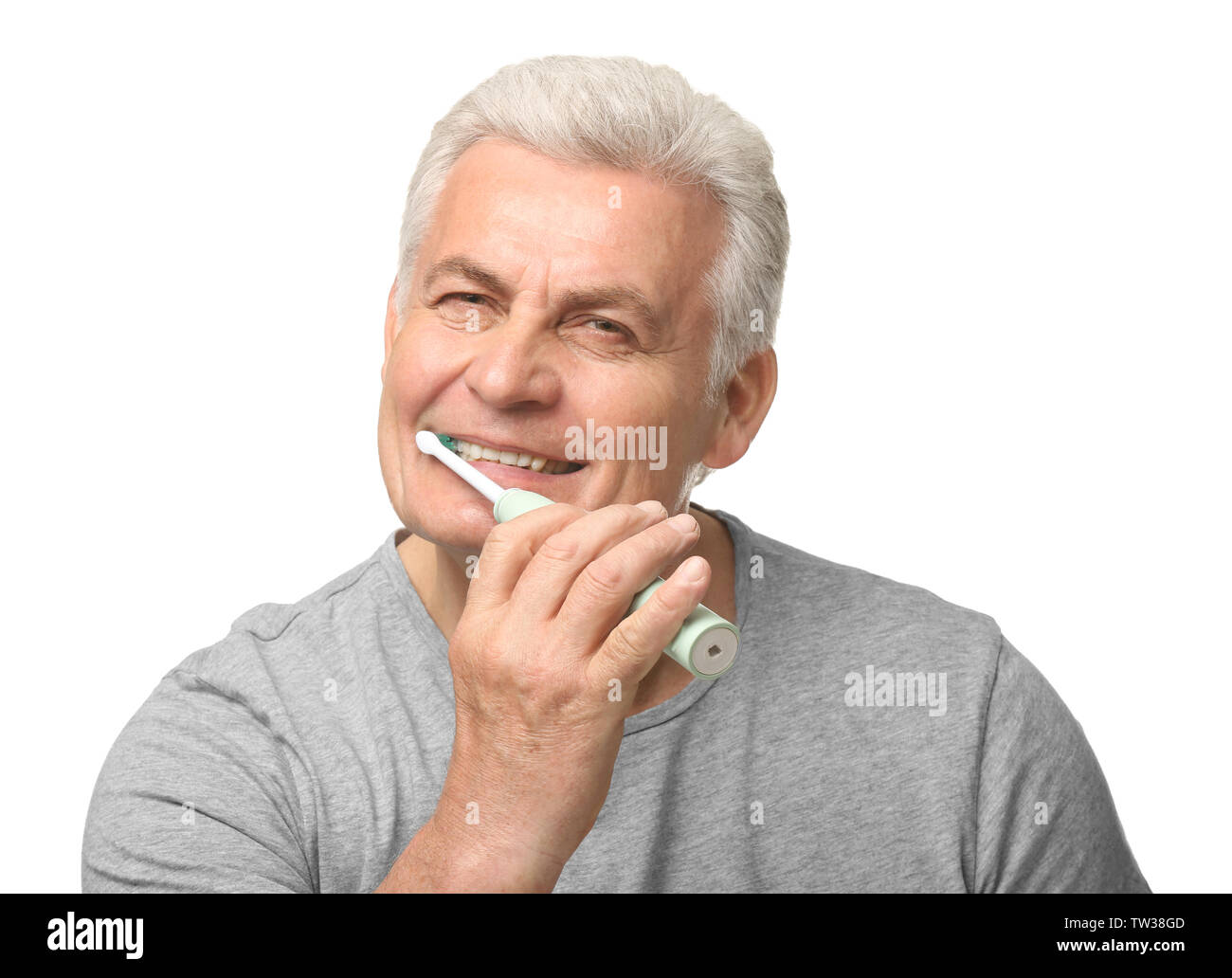 Senior man cleaning teeth on white background Stock Photo - Alamy
