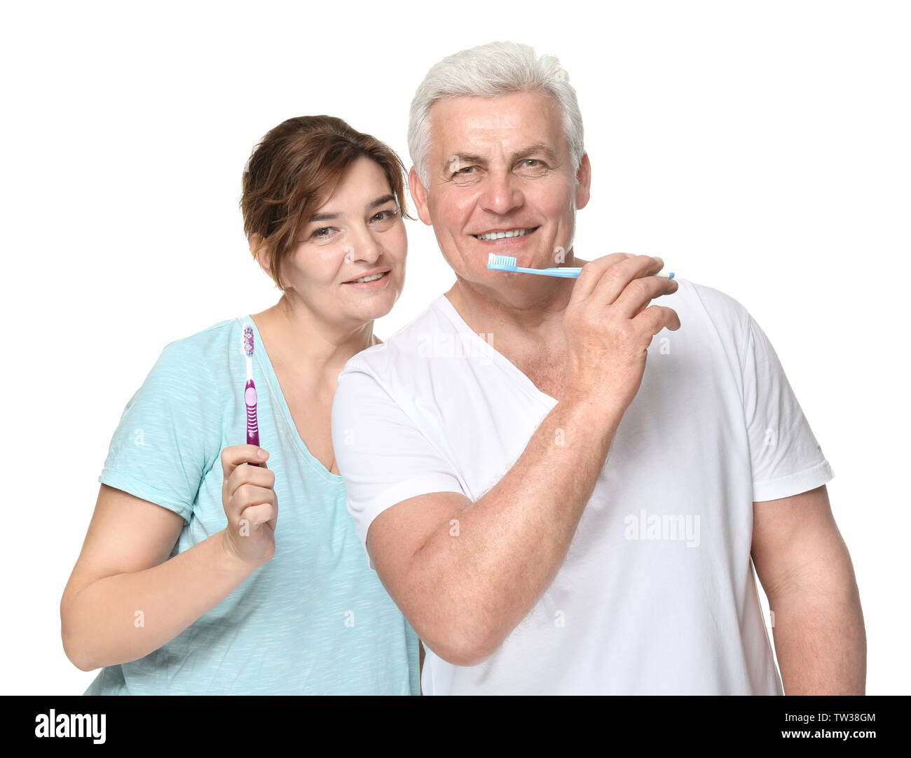 Senior couple with toothbrushes on white background Stock Photo - Alamy